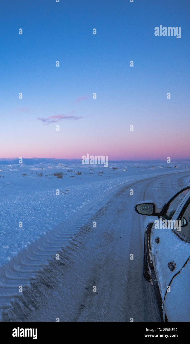 Icy landscape from a 4x4 car on a totally snowy road with tire tracks ...