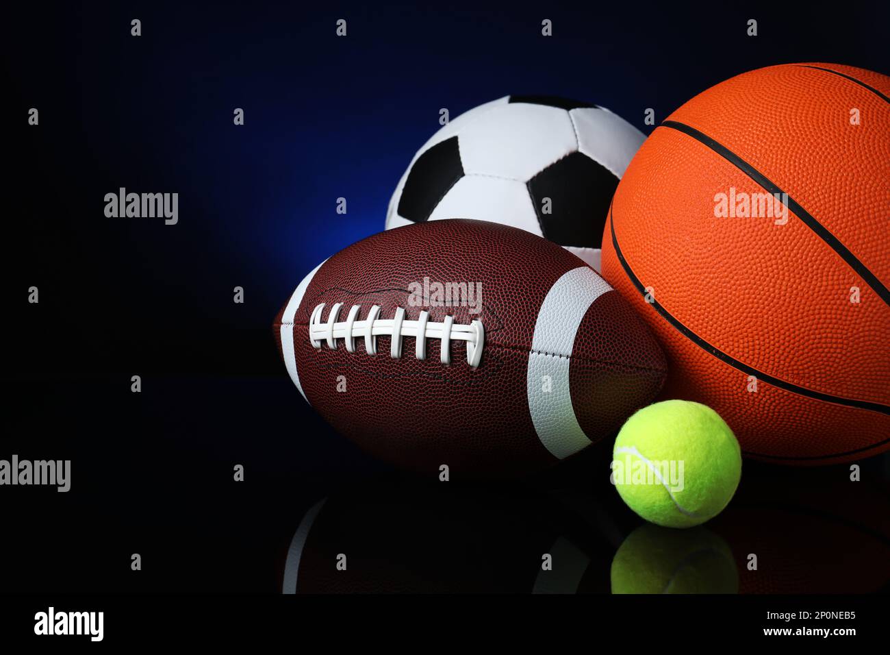 Set of different sport balls on black mirror surface Stock Photo - Alamy