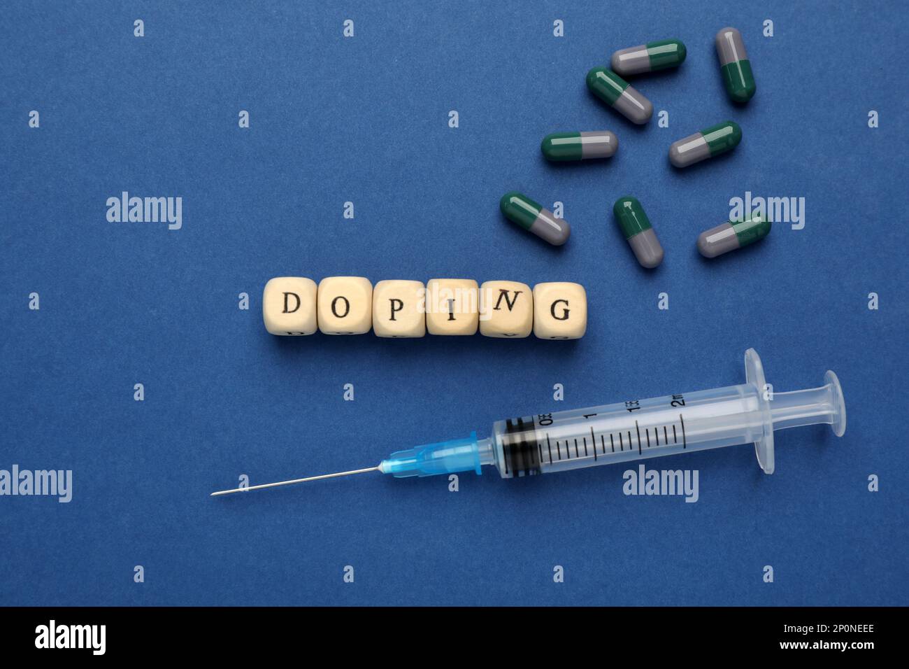 Wooden cubes with word Doping and drugs on blue background, flat lay ...