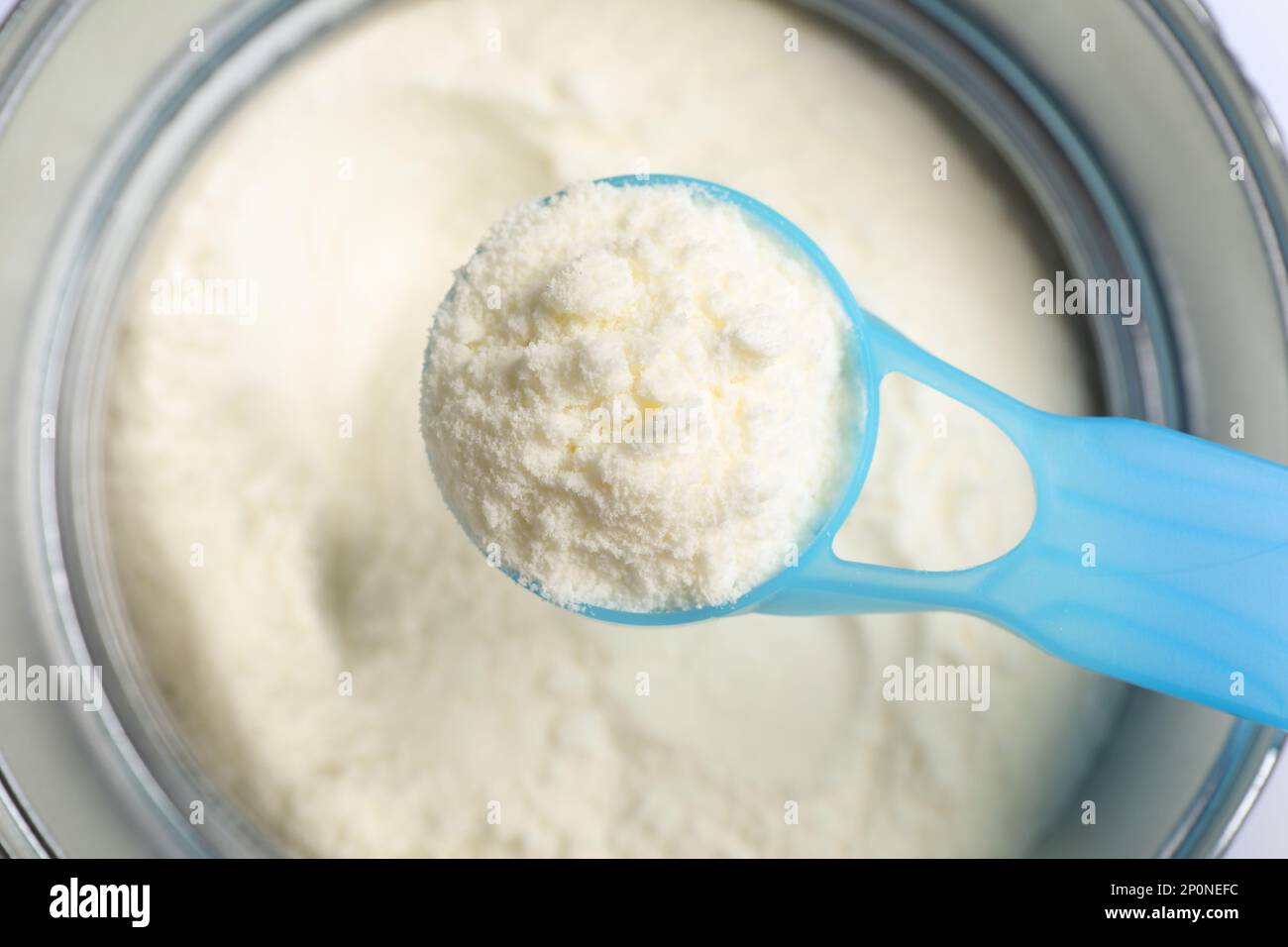 Scoop of powdered infant formula over can, top view. Baby milk Stock ...
