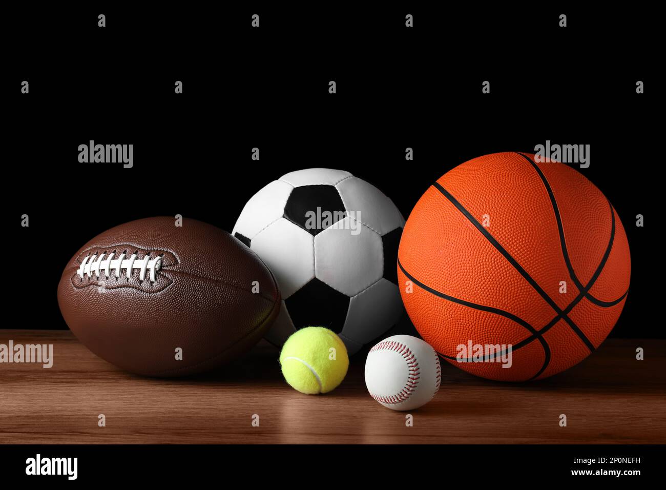 Set of different sport balls on wooden surface Stock Photo - Alamy