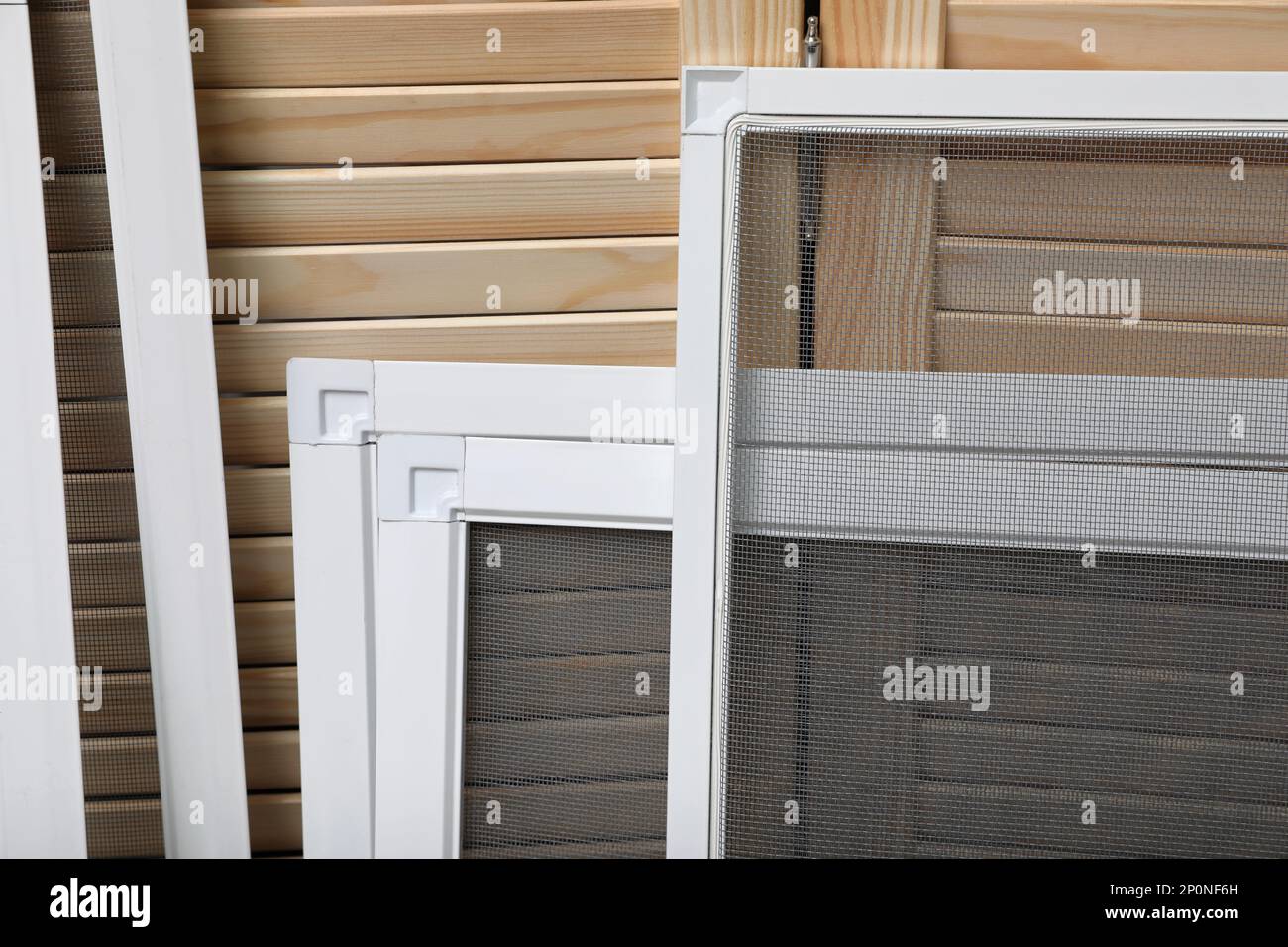 Set of window screens near wooden folding screen, closeup Stock Photo ...