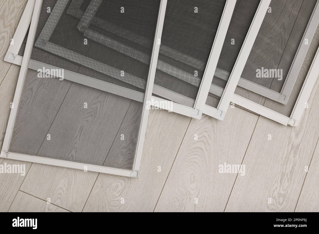 Set of window screens on wooden floor, flat lay Stock Photo - Alamy