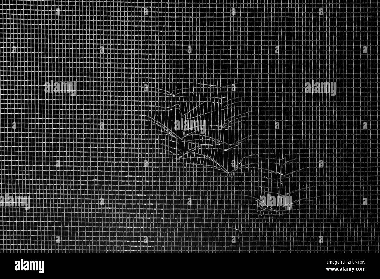 Torn window screen against black background, closeup Stock Photo - Alamy
