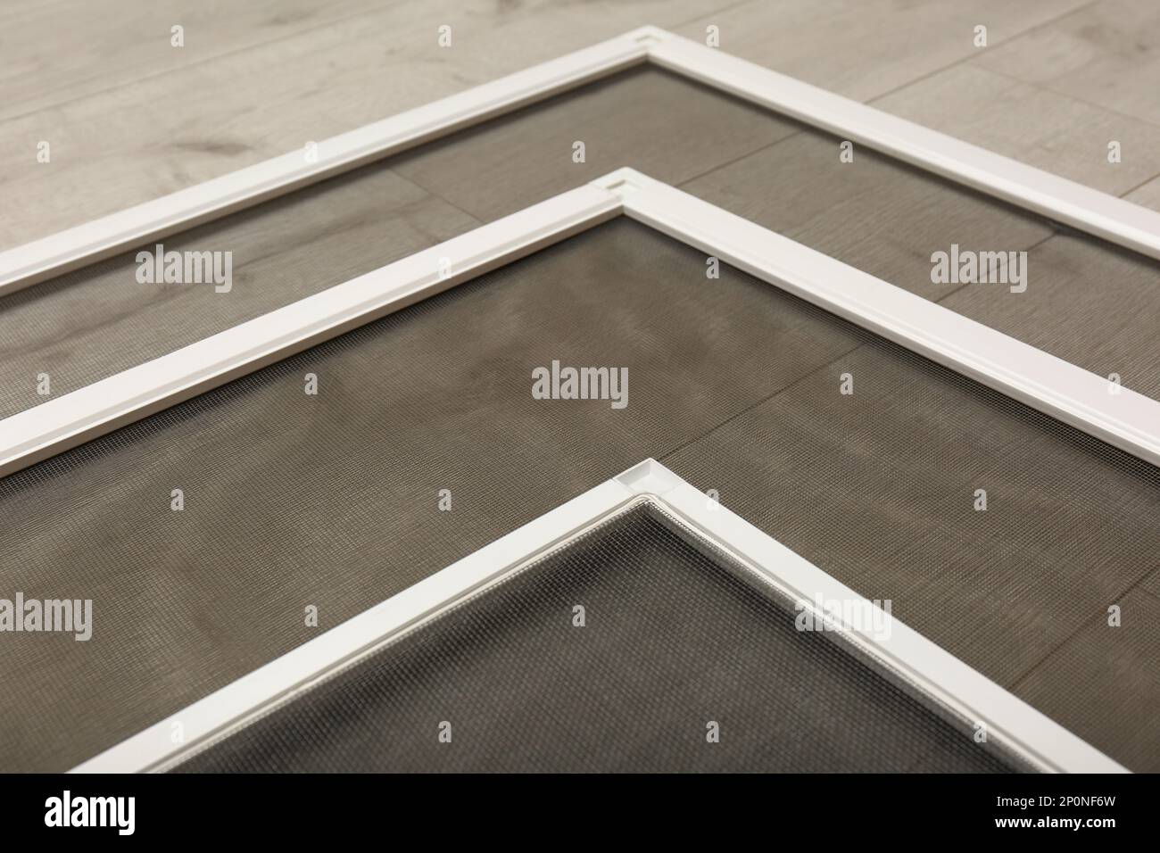 Set of window screens on wooden floor, closeup Stock Photo - Alamy