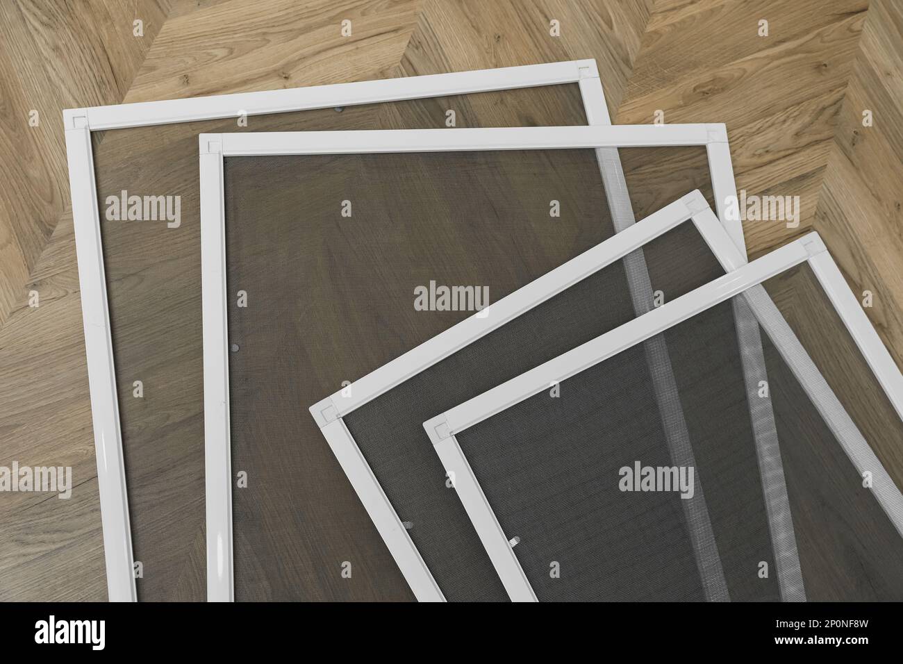 Set of window screens on wooden floor, flat lay Stock Photo - Alamy