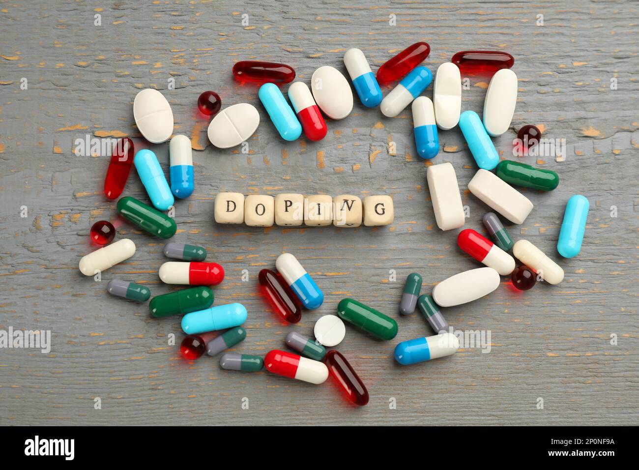 Cubes with word Doping and drugs on light grey wooden background, flat ...