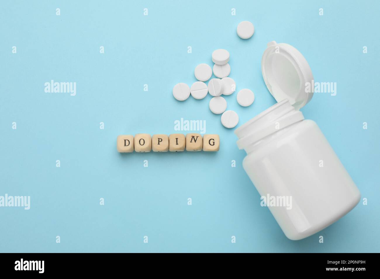 Wooden cubes with word Doping and drugs on turquoise background, flat ...