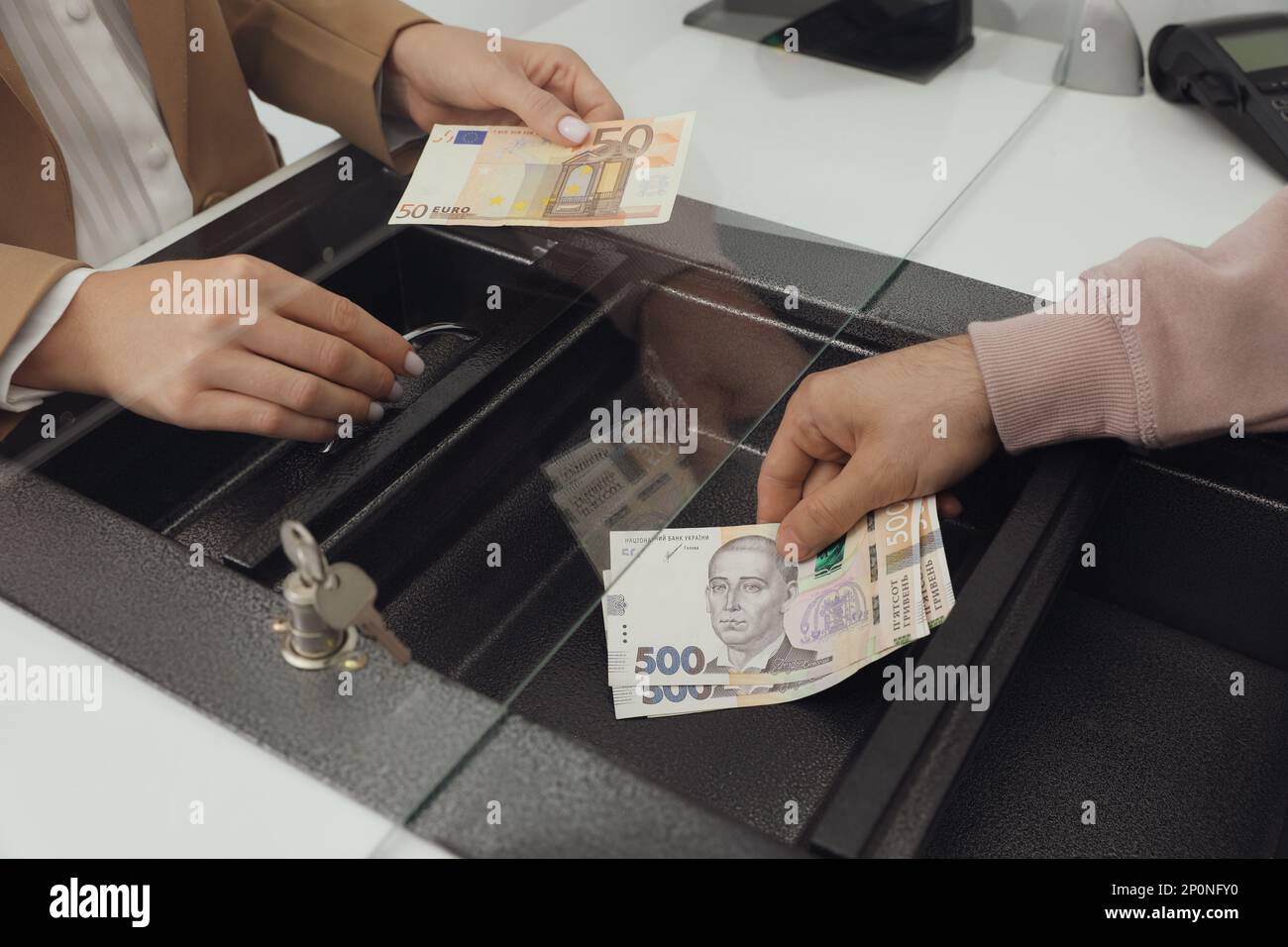 Man exchanging money at cash department window, closeup Stock Photo - Alamy