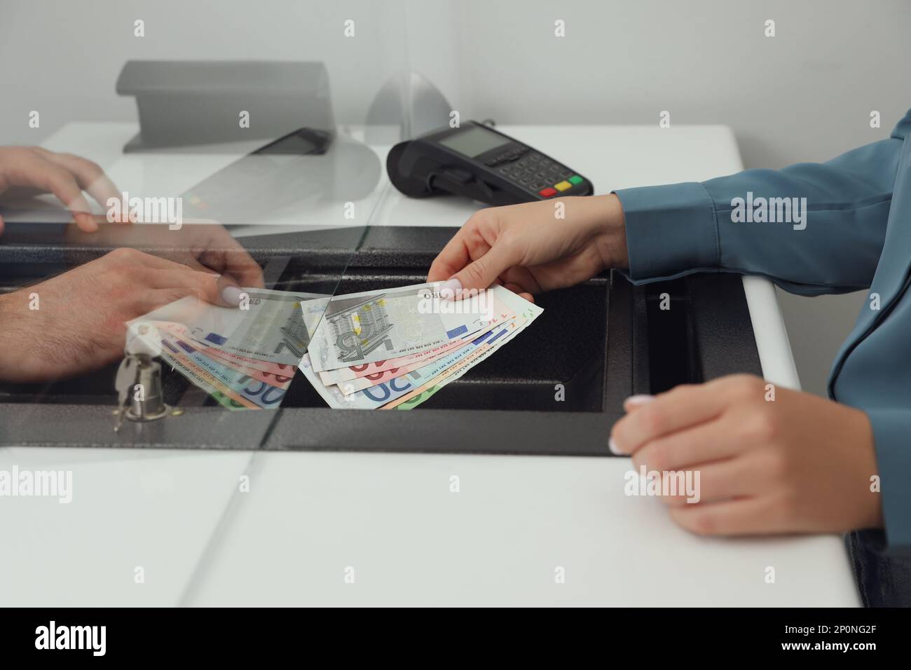 Woman giving money to cashier in bank, closeup. Currency exchange Stock ...