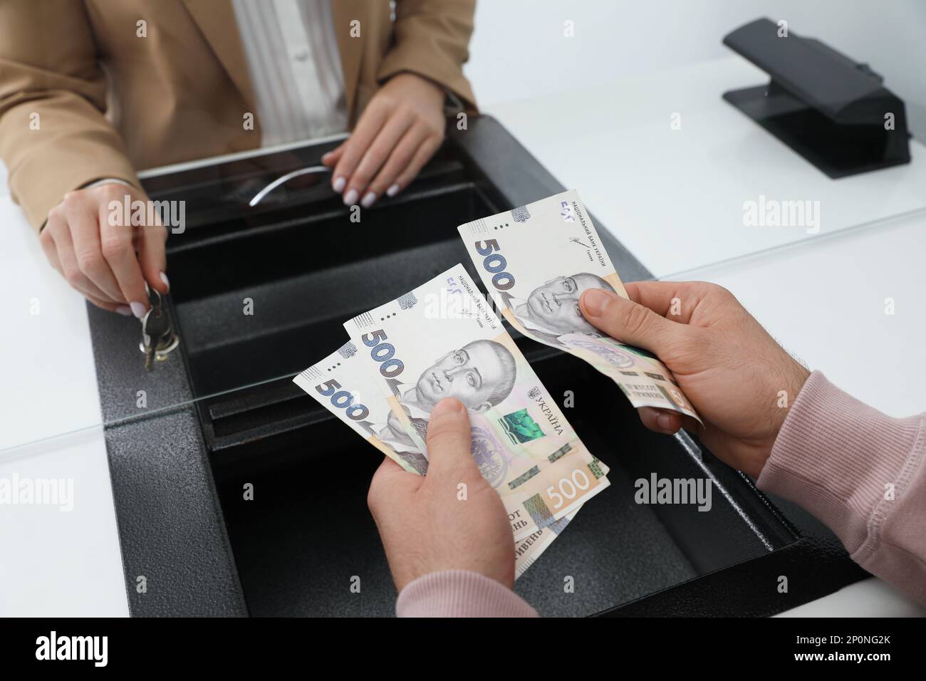 Man with money at cash department window, closeup. Currency exchange ...