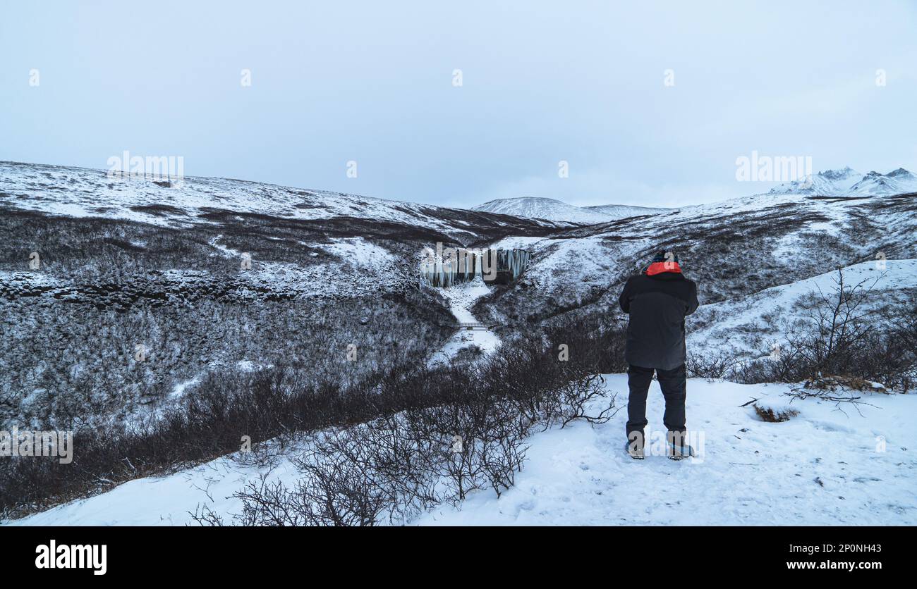 Man standing full length sheltered from the polar cold, taking photos ...