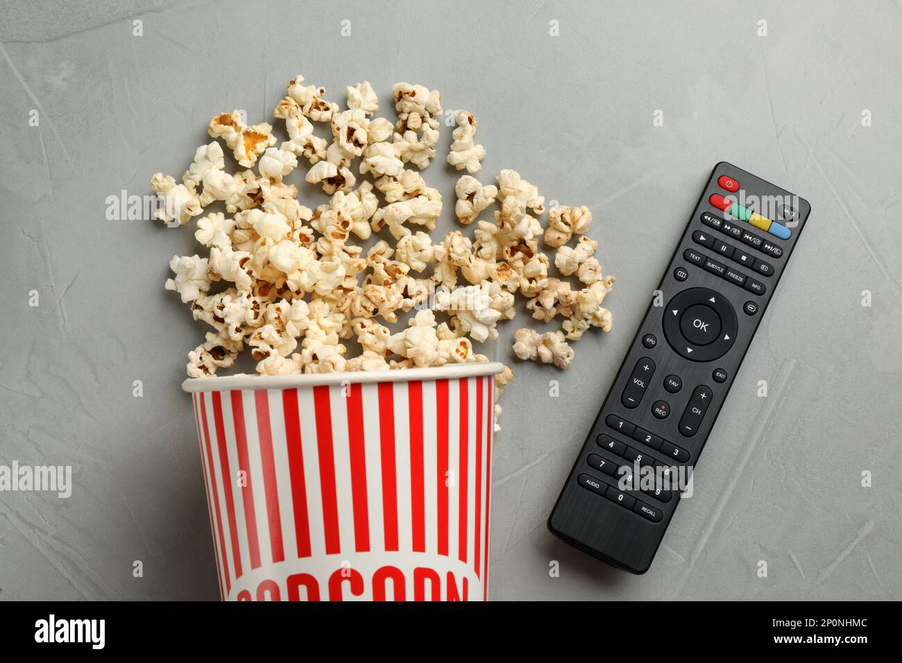 Modern tv remote control and popcorn on grey table, flat lay Stock ...