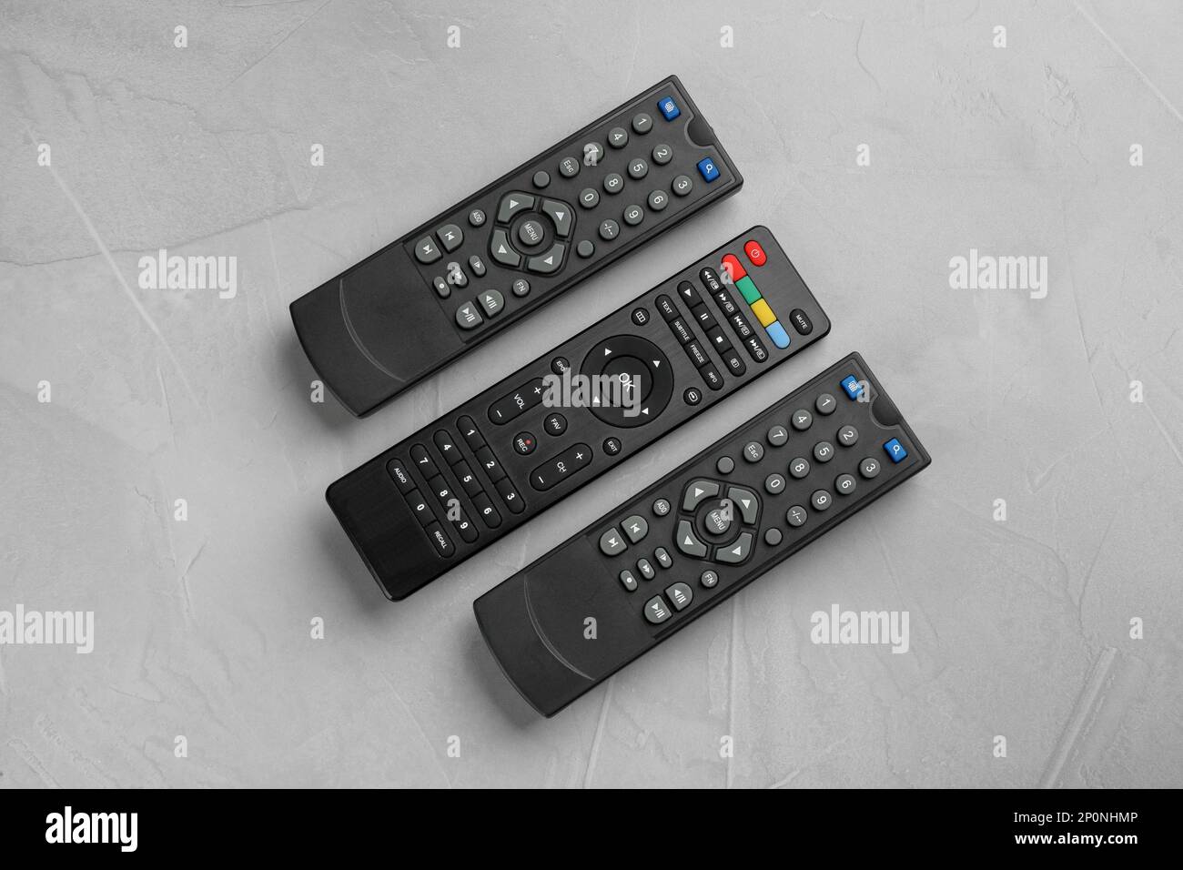 Modern tv remote controls on grey table, flat lay Stock Photo - Alamy