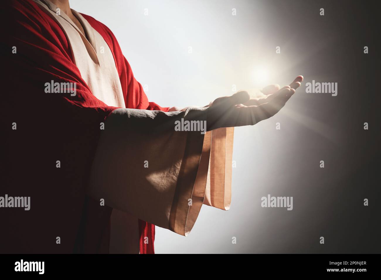 Jesus Christ on grey background, closeup. Miraculous light in hands ...