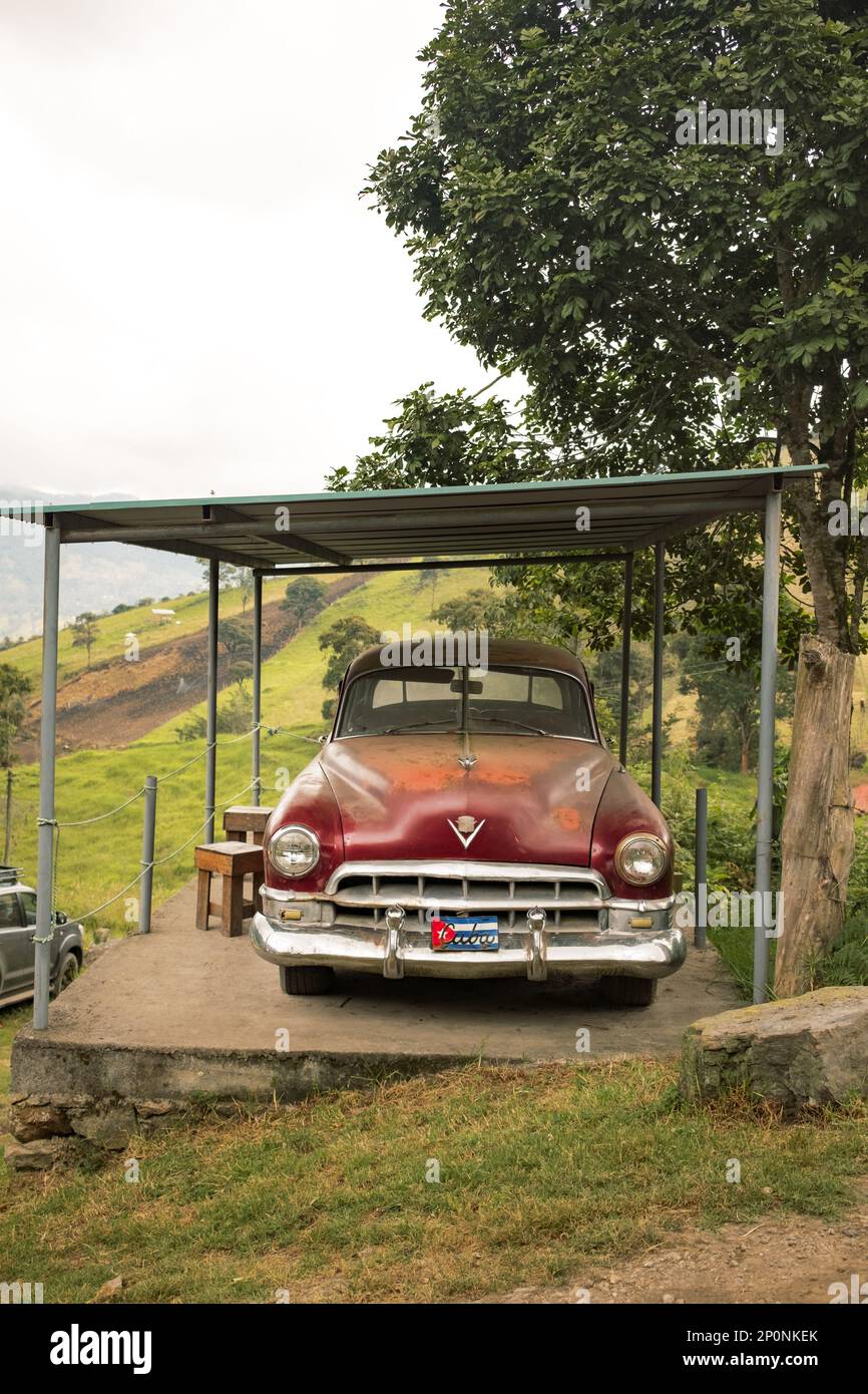 An old Chevrolet Car in a carport on the countryside with a cubanian ...