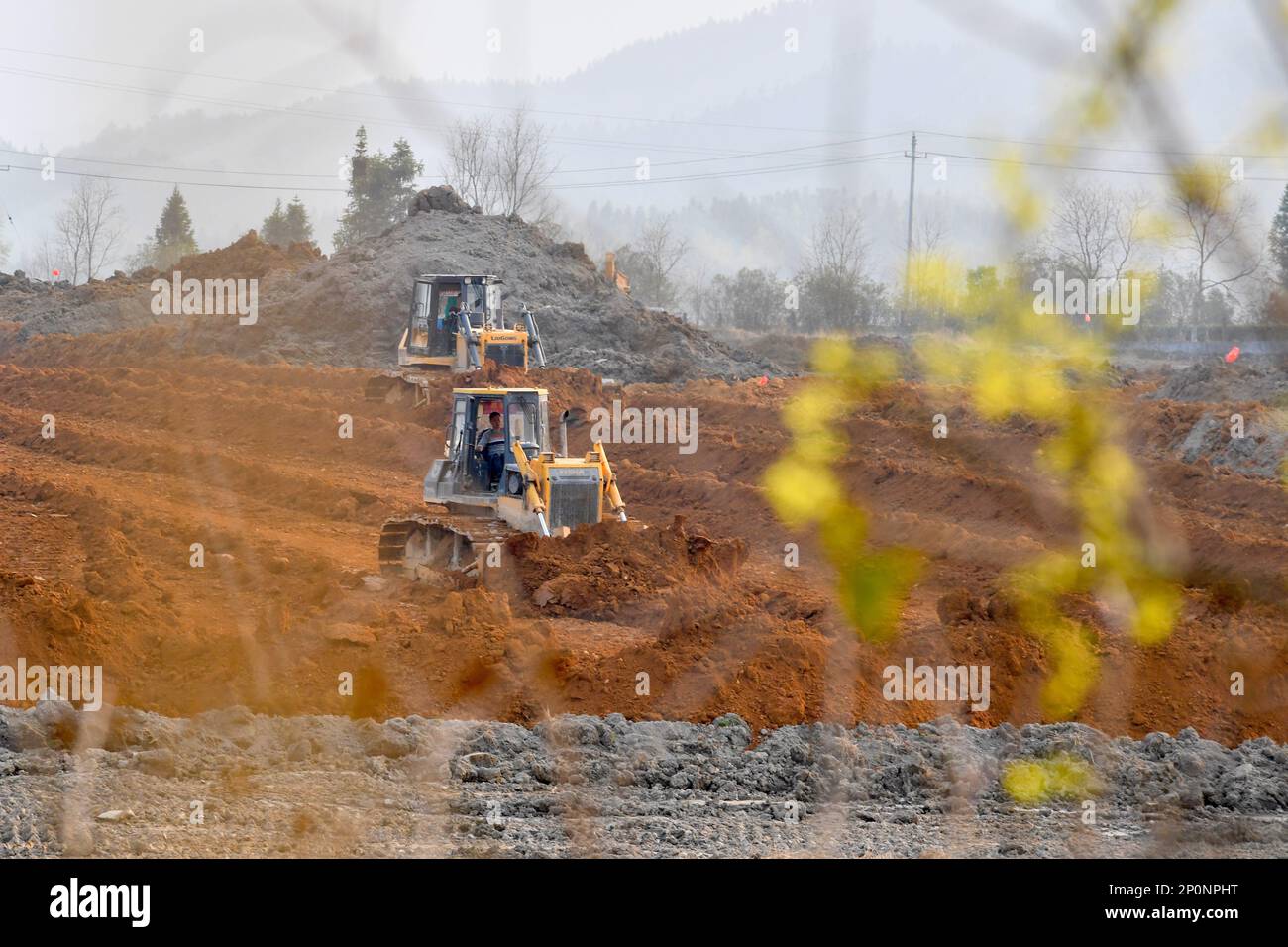 Pucheng. 2nd Mar, 2023. Bulldozers work to build high-standard ...