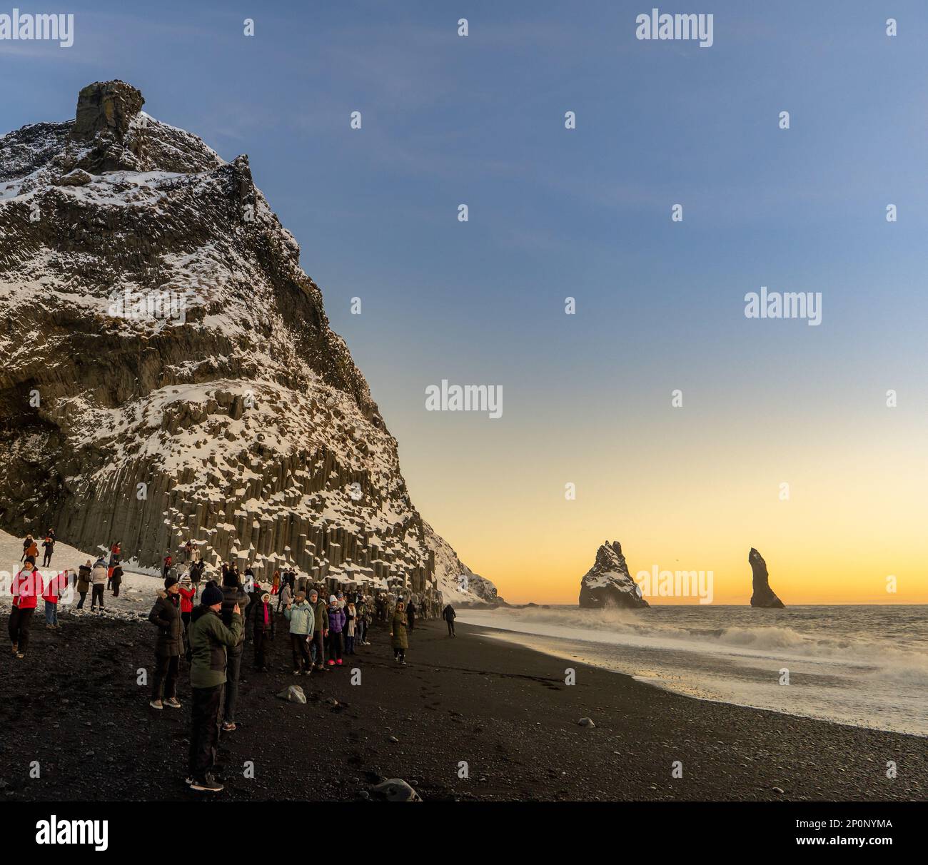 Reynisfjara black sand beach at sunset and the basalt formations ...