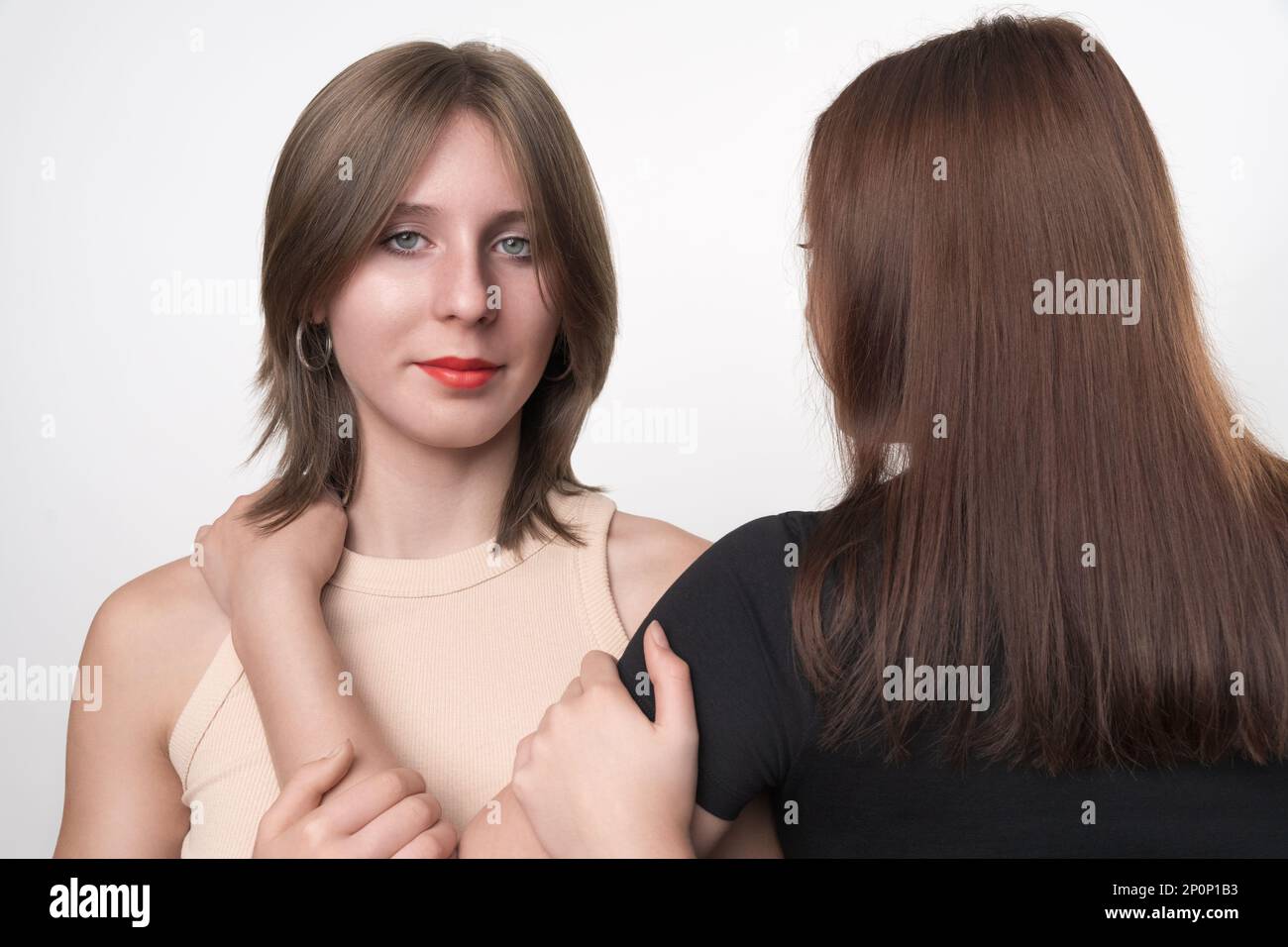 Portrait of daughter with gray eyes and long hair standing facing ...