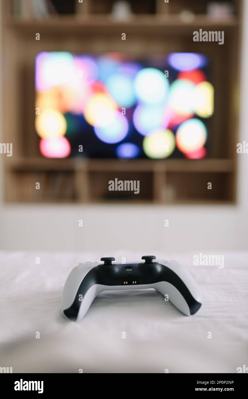 Game controller, joystick on TV screen background. Playing game console ...