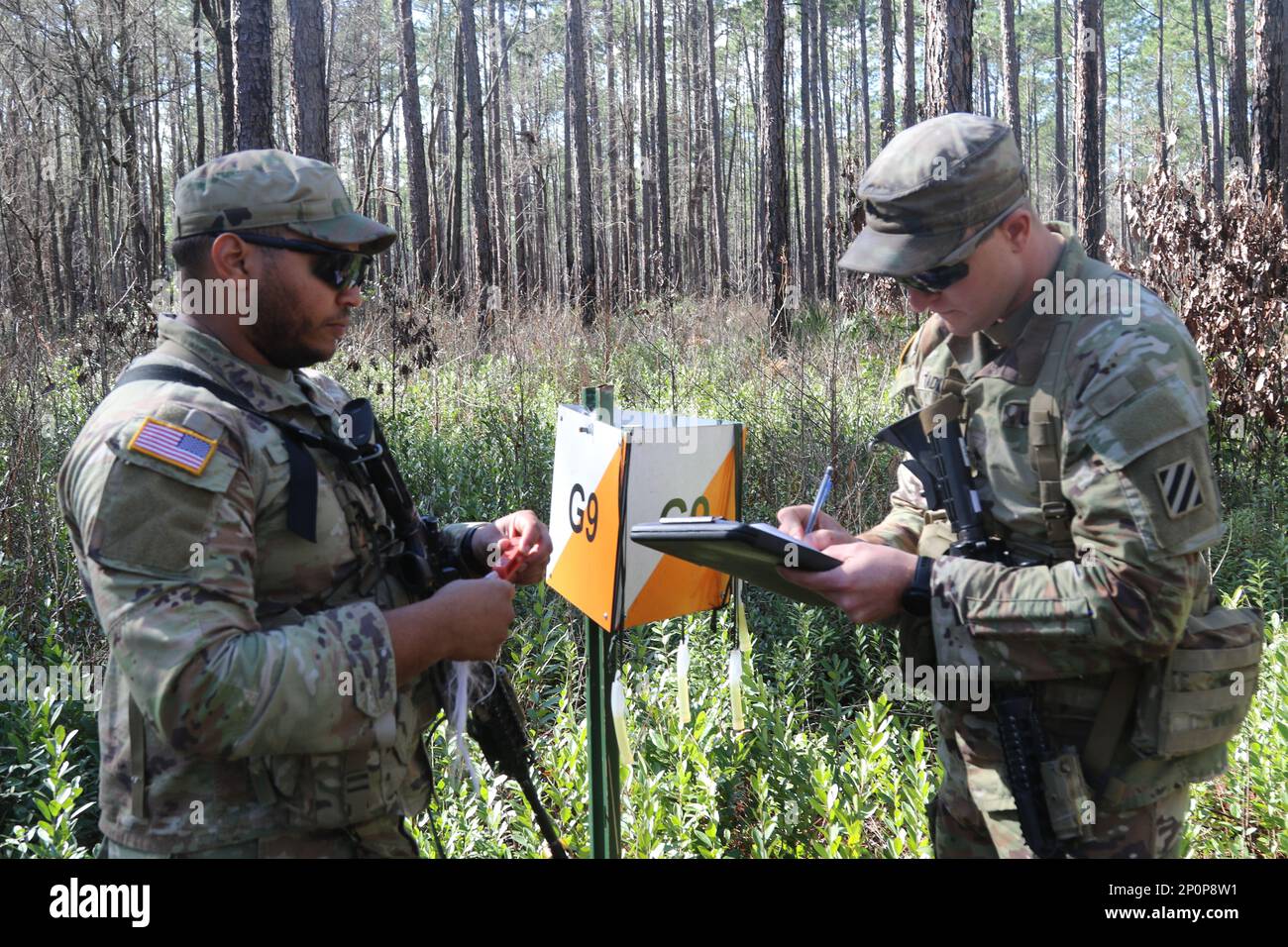 3rd Infantry Division Soldiers review their land navigation coordinates ...