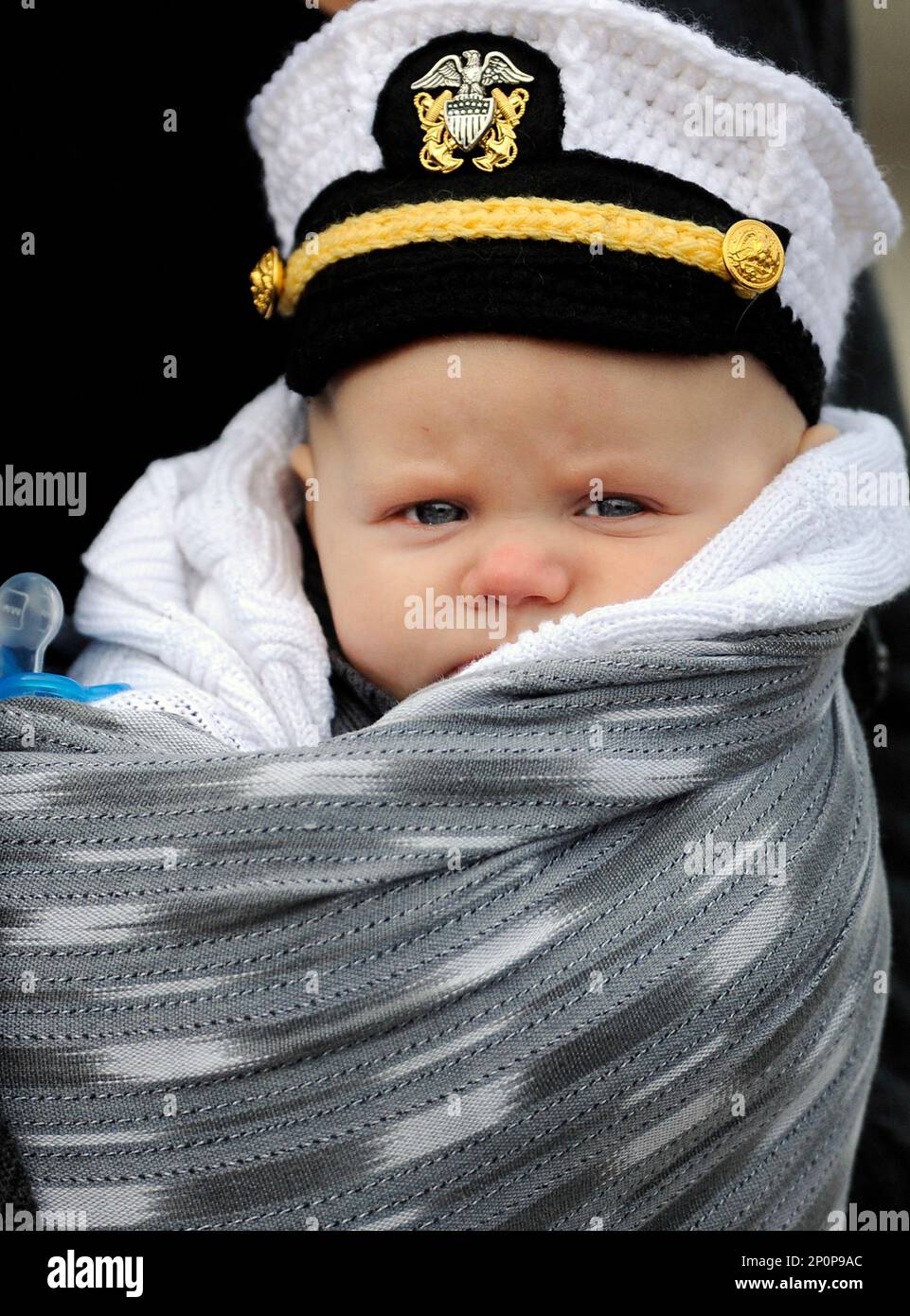 A baby wears a knitted Navy during a commissioning ceremony for the U.S ...