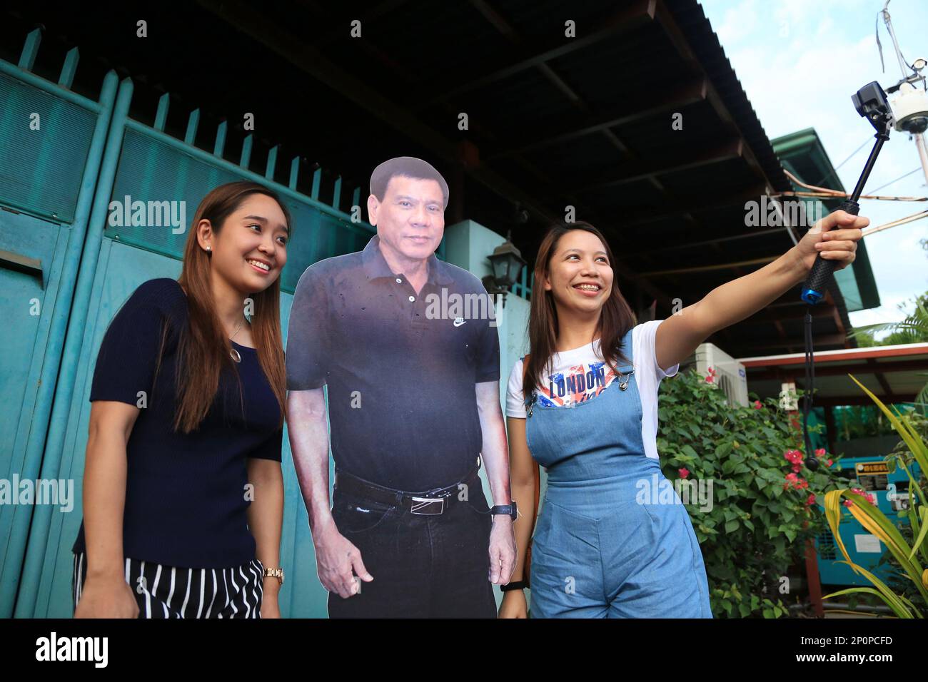 Visitors pose with a life-size picture of Philippine President Rodrigo ...