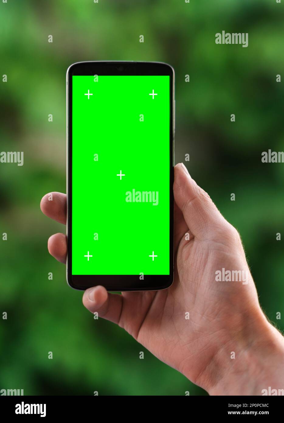 Mobile phone with a green screen in a male hand Stock Photo - Alamy