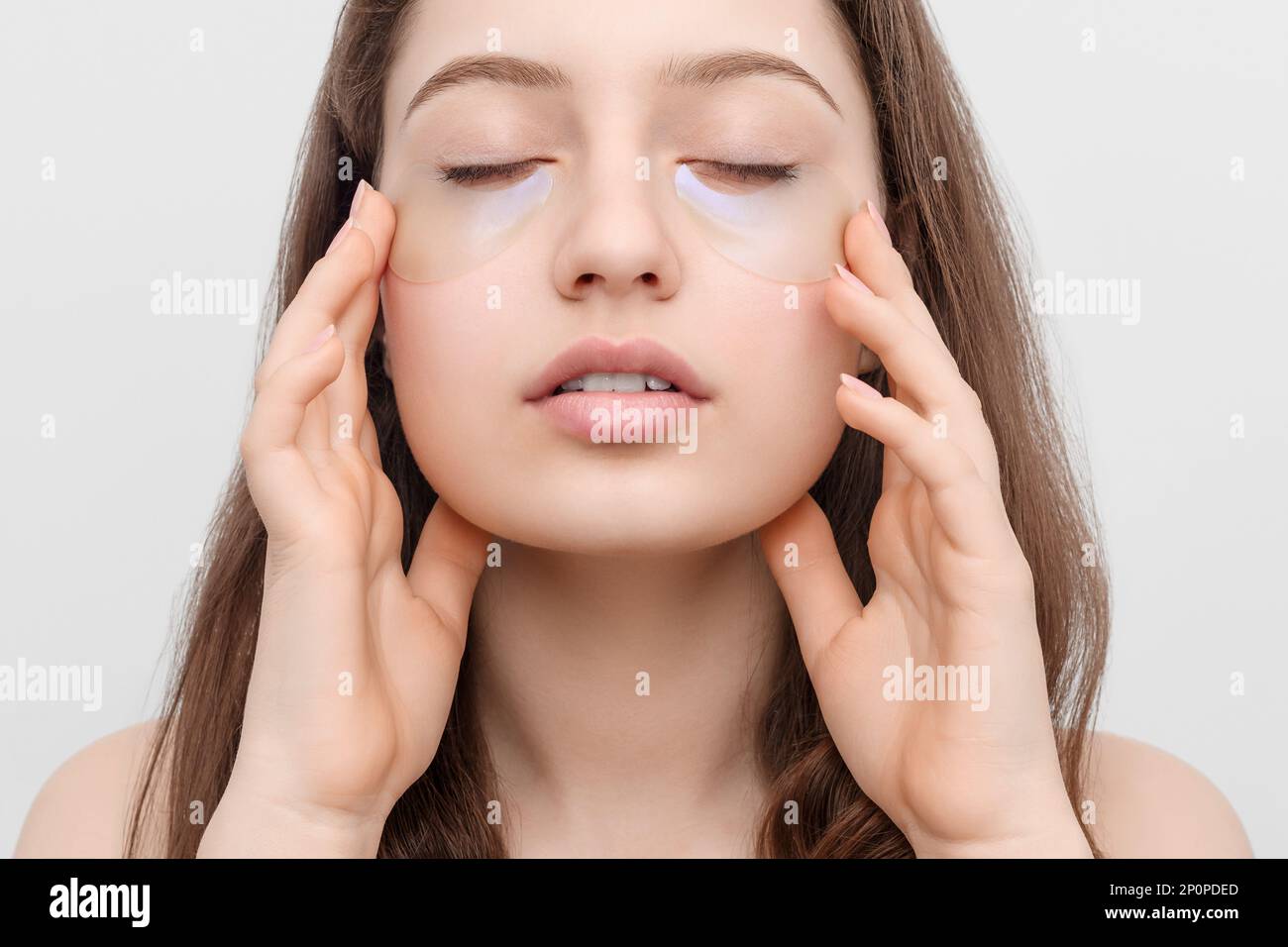 A Beautiful Young Woman Applies Eye Patches Eyes Closed Gently