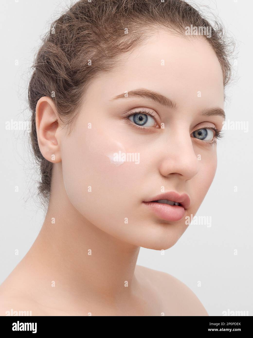 Portrait of a beautiful blue eyed young woman with smear of a face ...