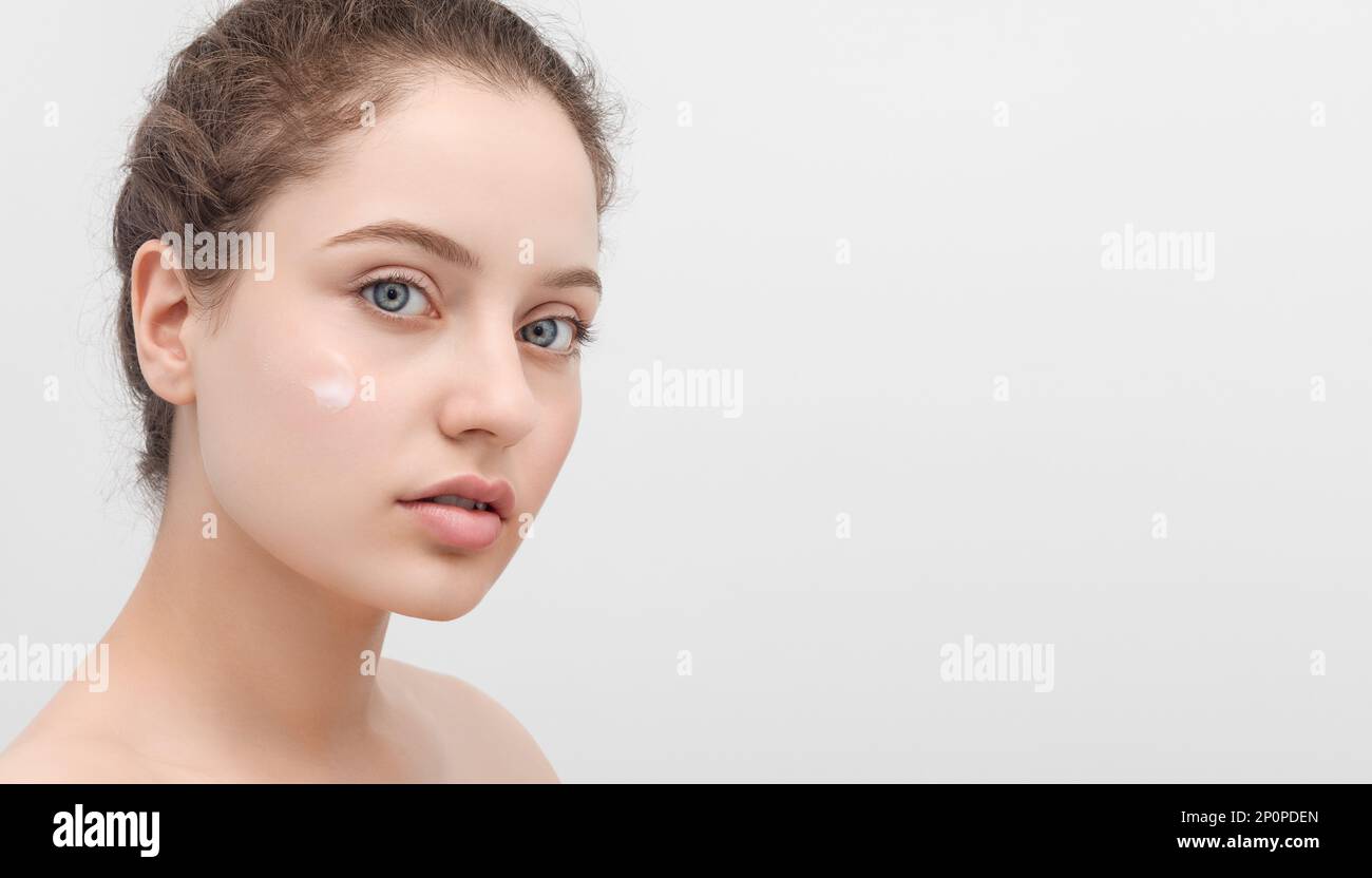 Portrait of a beautiful blue eyed young woman with smear of a face ...