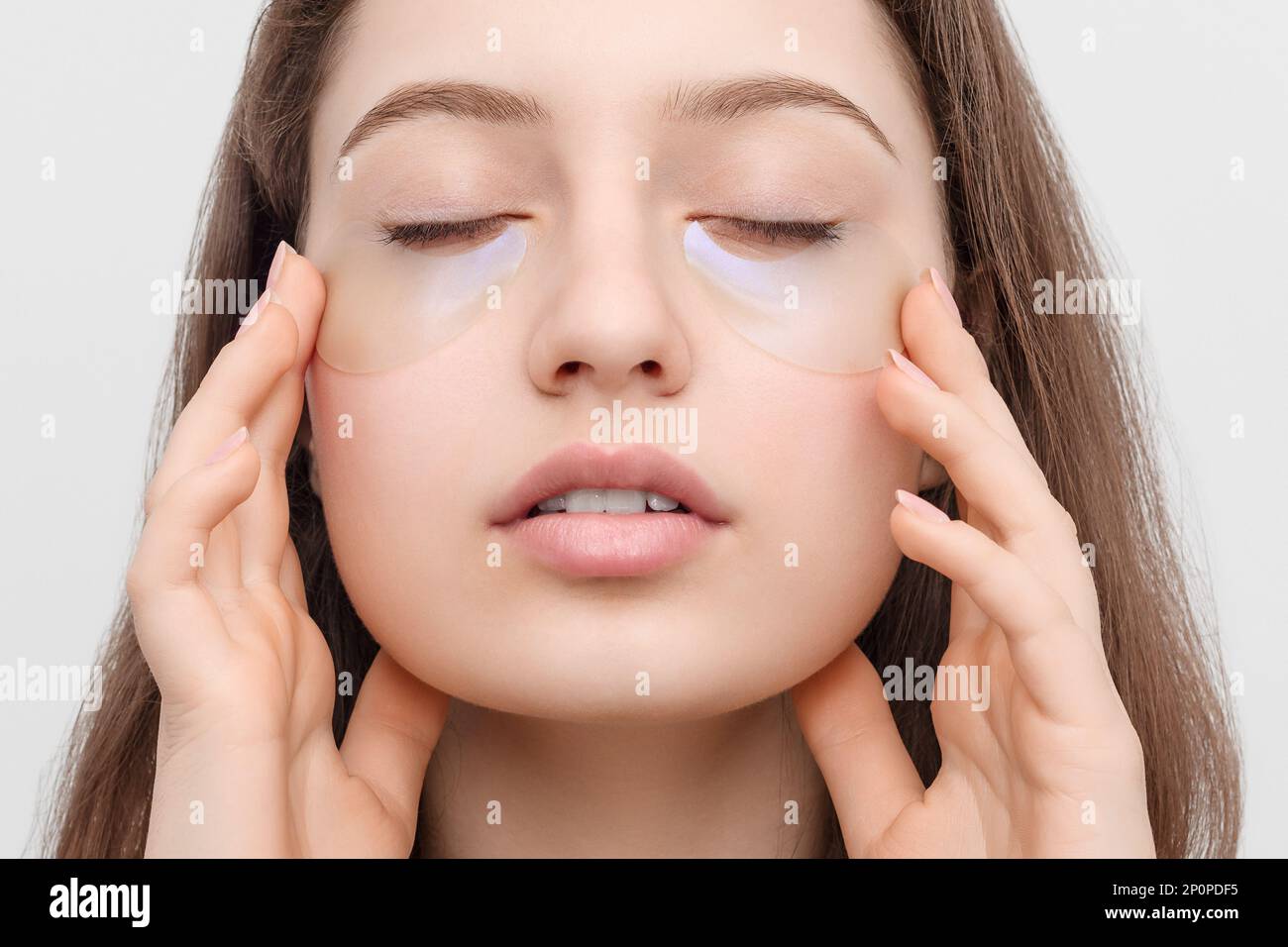 A Beautiful Young Woman Applies Eye Patches Eyes Closed Gently