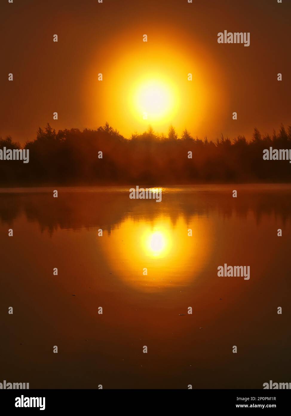 The first minutes of sunrise over the river, the sun disc appeared from ...