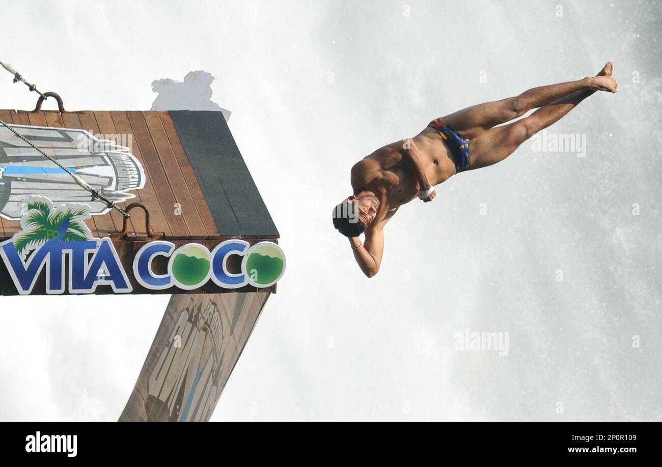 A contestant dives during the Vita Coco Waterfall Diving competition at ...