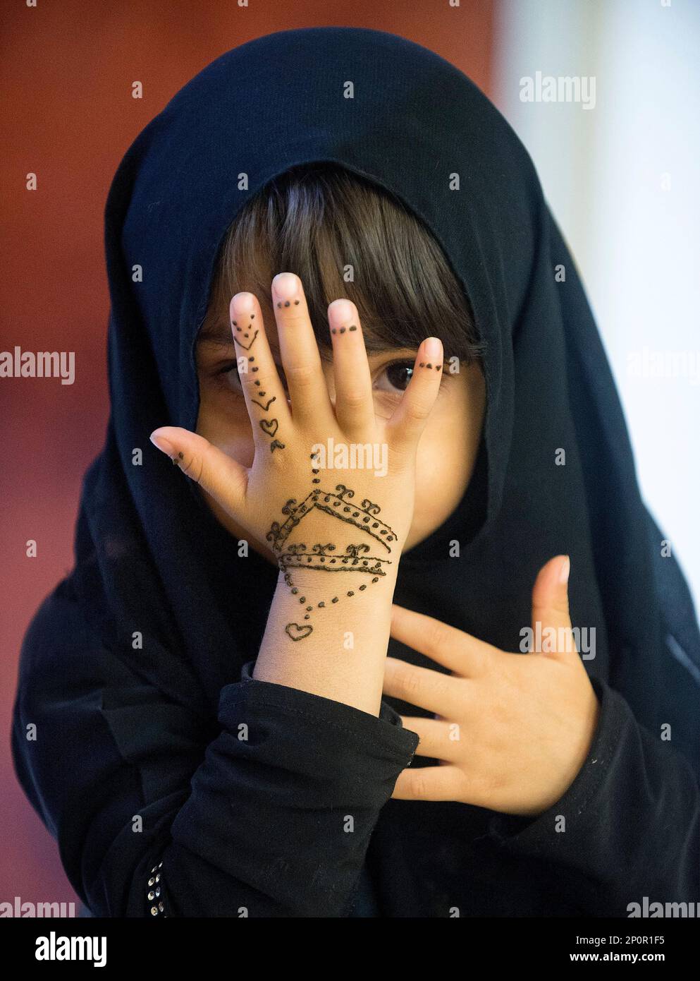 Safiyya Rukmuppeen, 4, of Brea, Calif., shows off her henna tattoo to ...