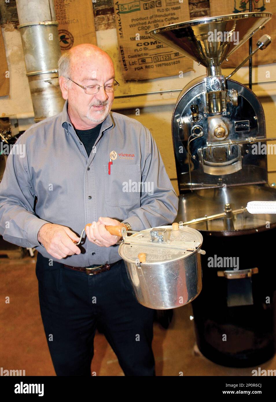 Vienna Coffee owner John Clark shows the popcorn popper he first used ...