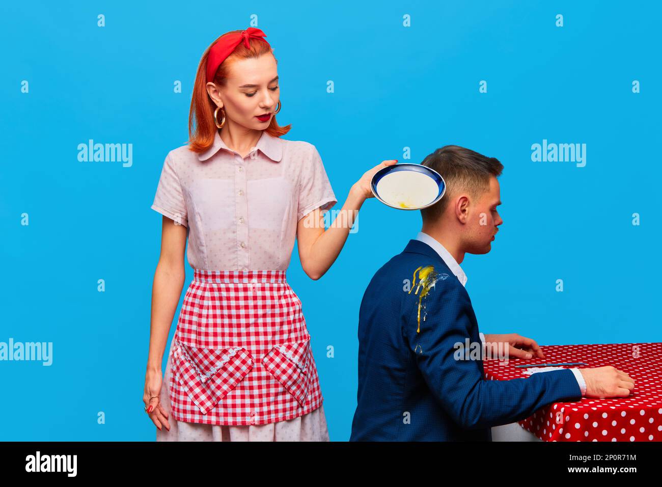 Young red head woman dropping breakfast with fried eggs at males ...