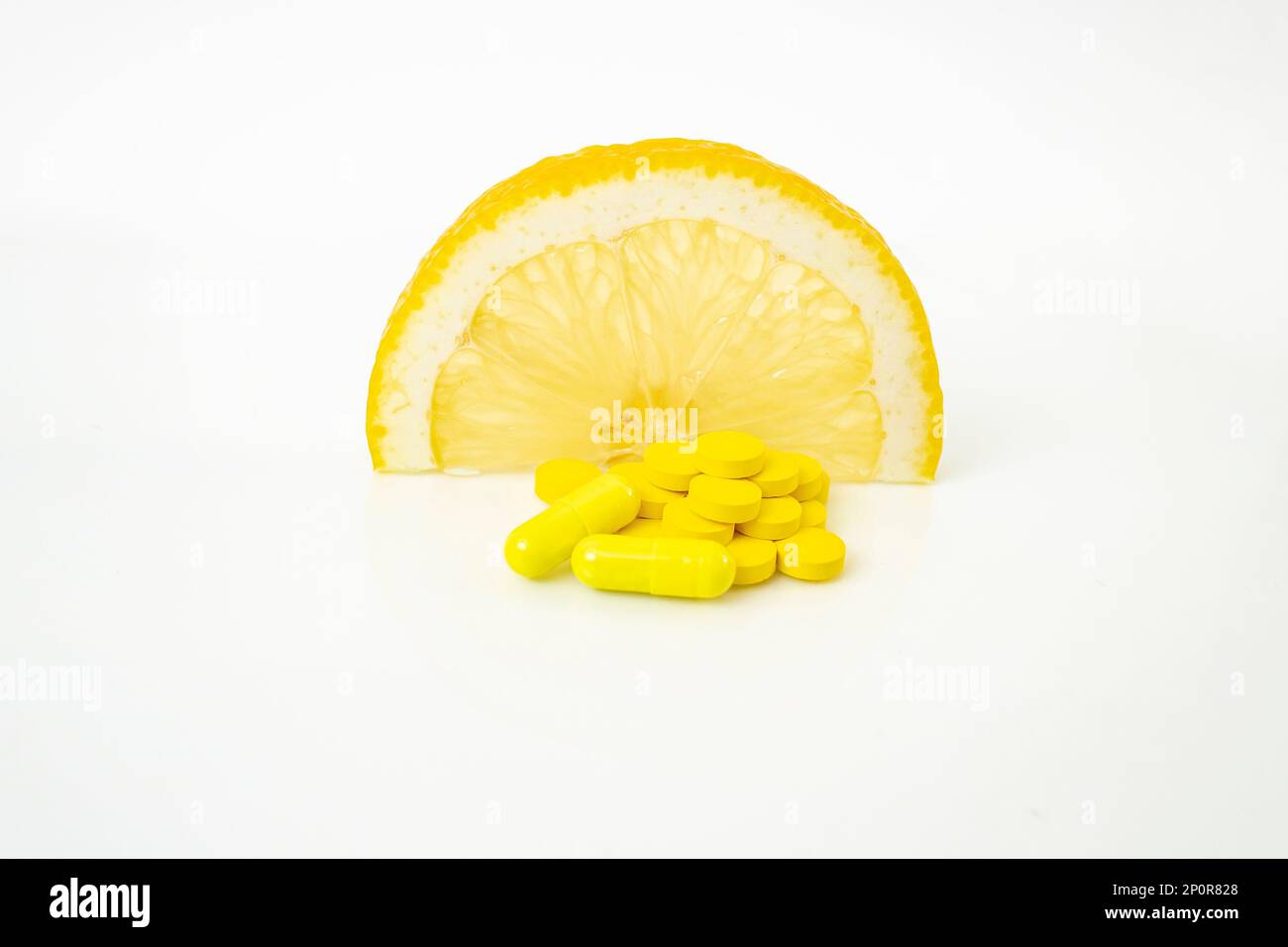 Lemon slice and yellow pills isolated on white background Stock Photo ...