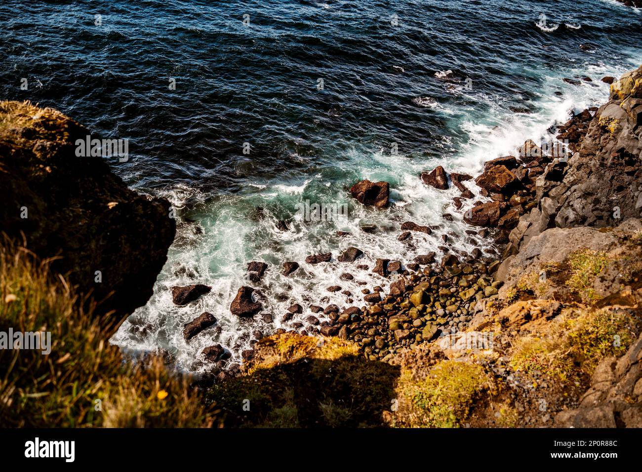 Waves crashing on rocks below cliff on Westman Island, Southern Iceland ...