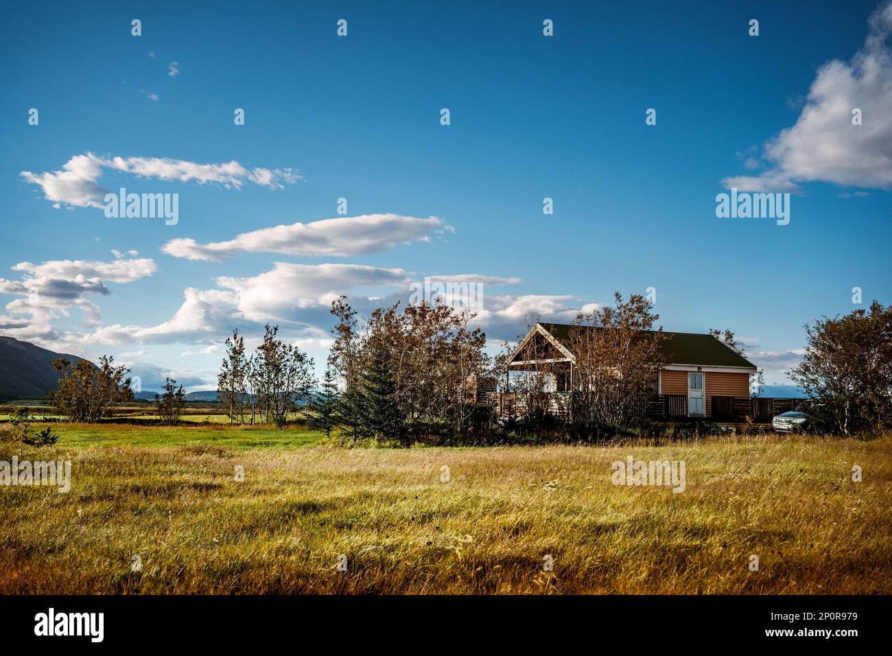 Remote chalet in Iceland with mountain in background and blue sky Stock ...