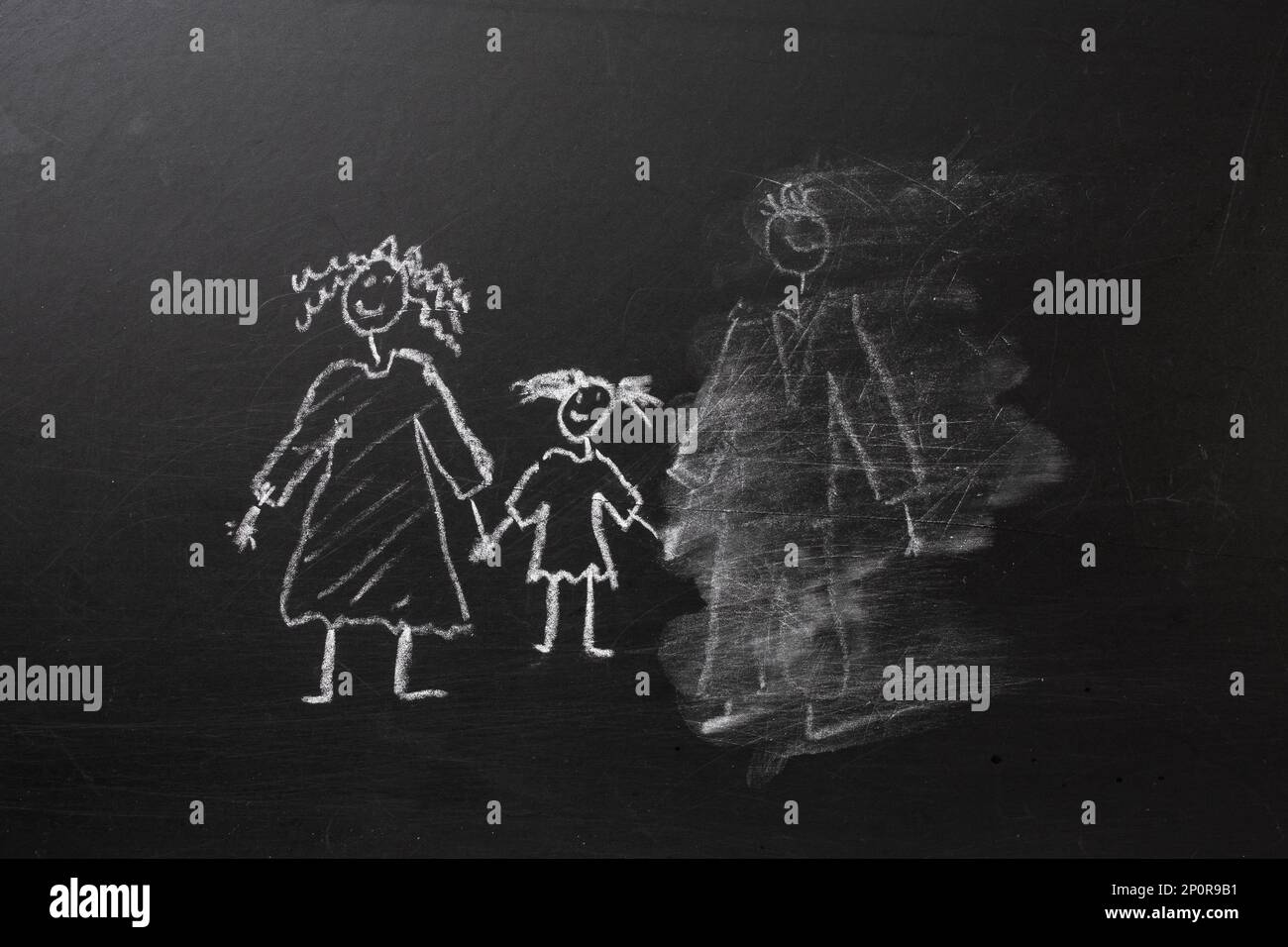 Chalk drawing of a child and parents on a blackboard, divorce trauma ...