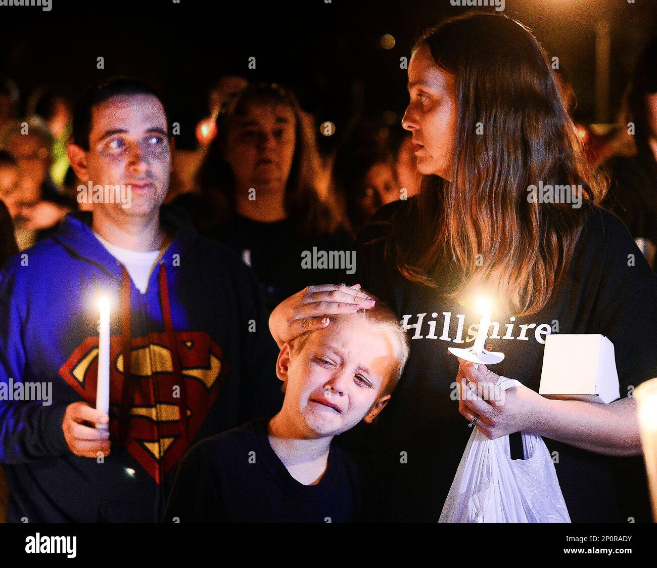 Caden Root, 10, center, expresses his feeling as his parents David ...