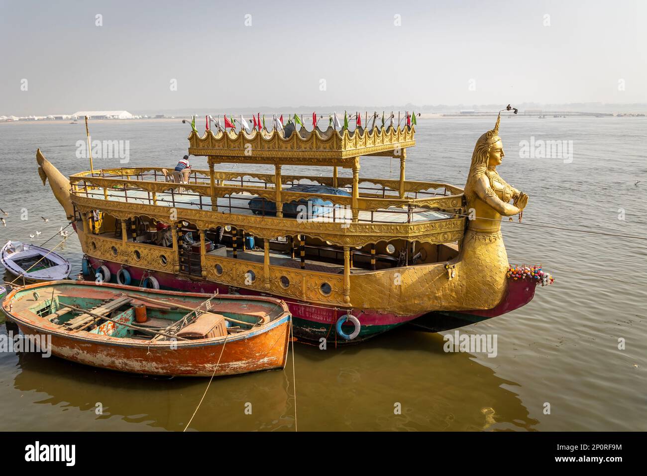 A grand boat on the river with a large golden figurehead Stock Photo ...