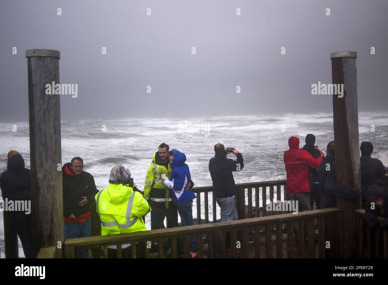 Park visitors take photos from atop a viewing deck overlooking the ...