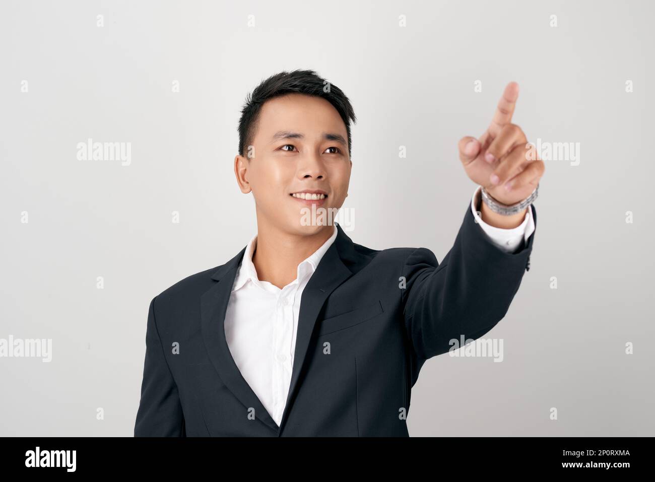 Smiling young guy touching invisible wall Stock Photo - Alamy