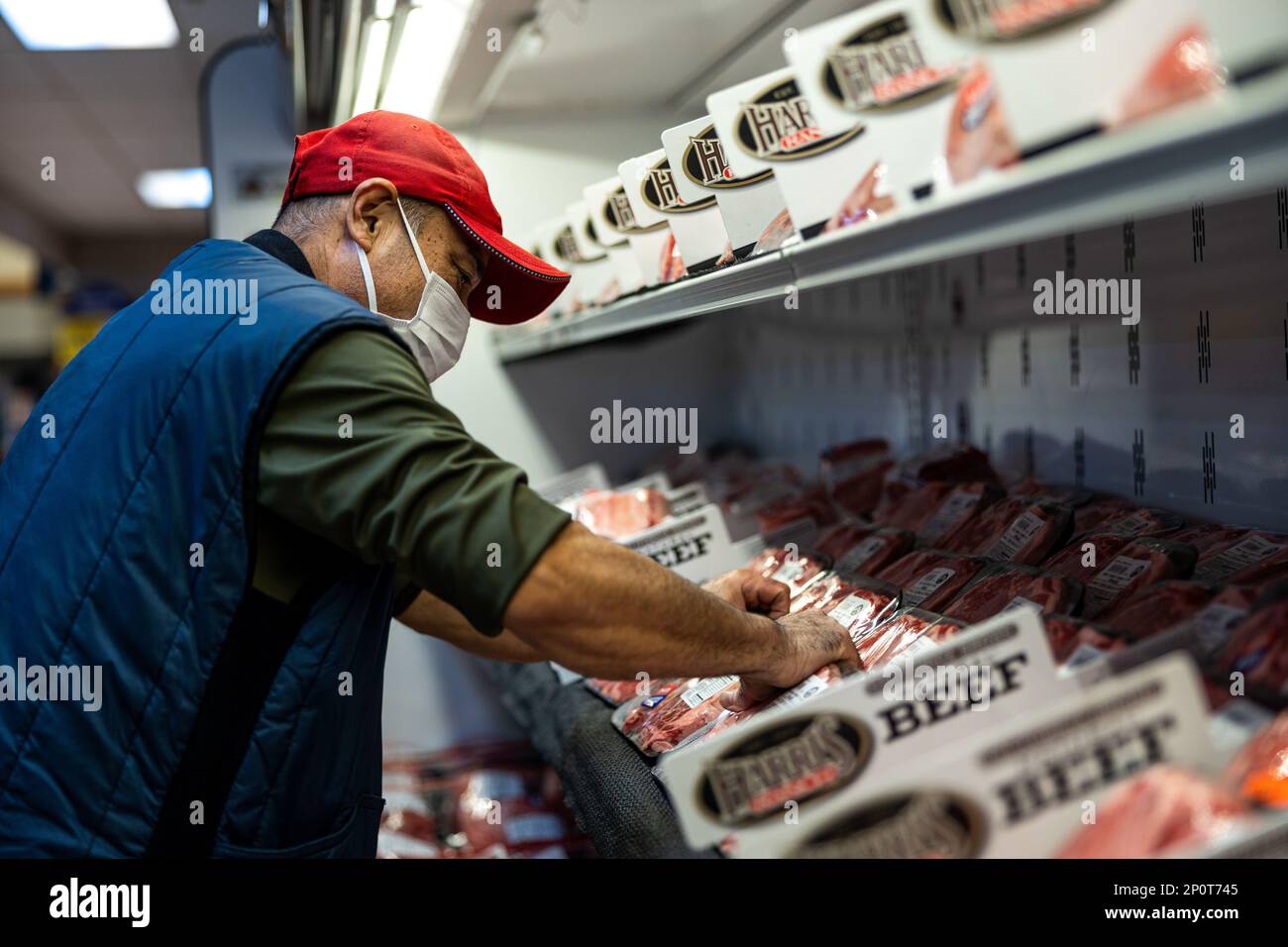 A worker at the Camp Foster Commissary stocks freshly cut meat on Camp ...