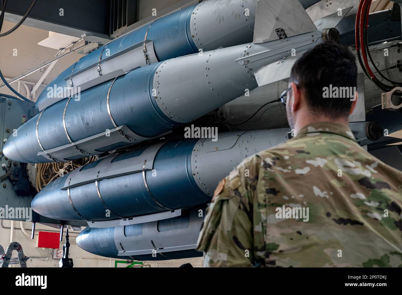 A 7th Aircraft Maintenance Squadron weapons load crew member assists in ...