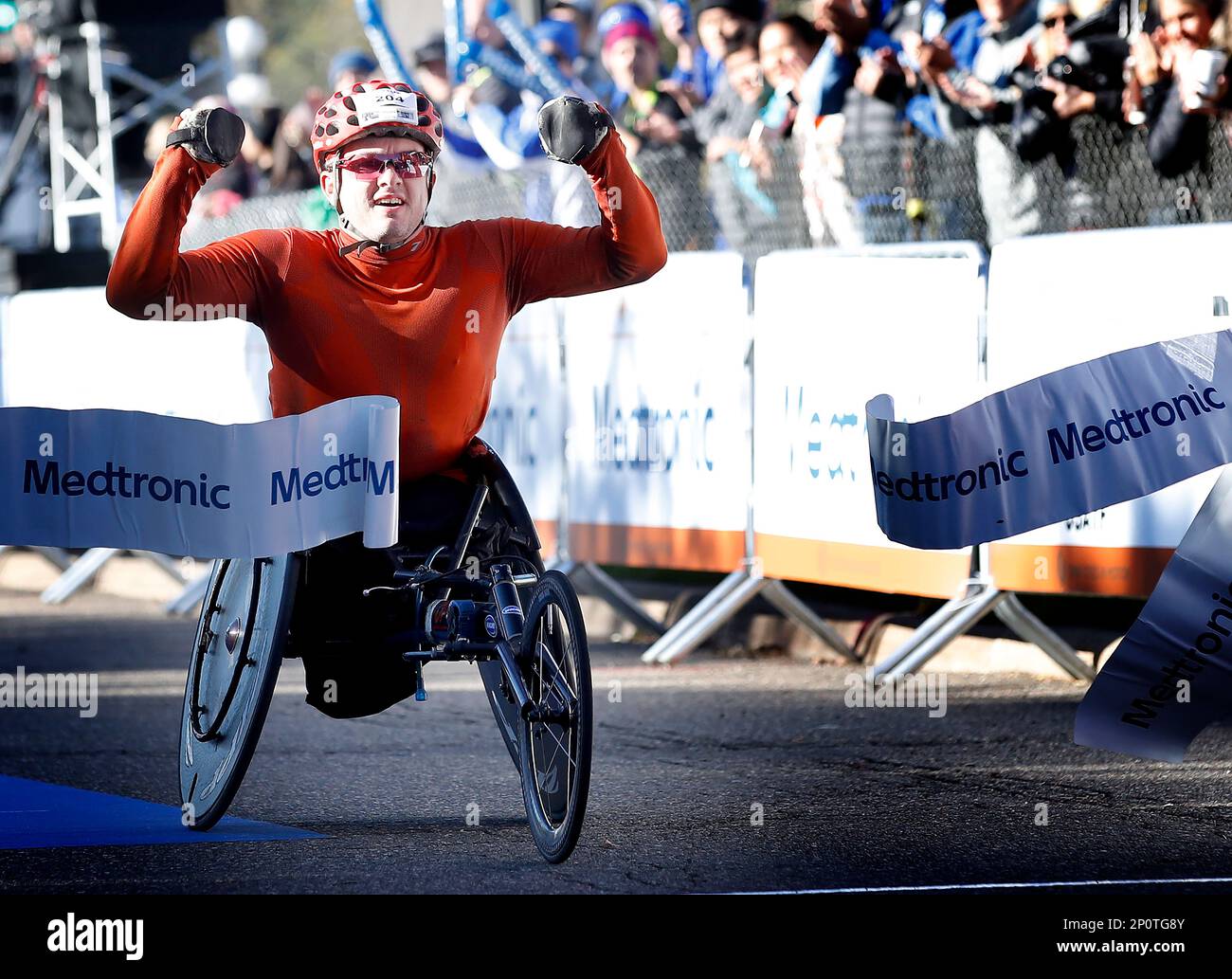 Tyler Byers crosses the finish line to become the Twin Marathon wheeler ...