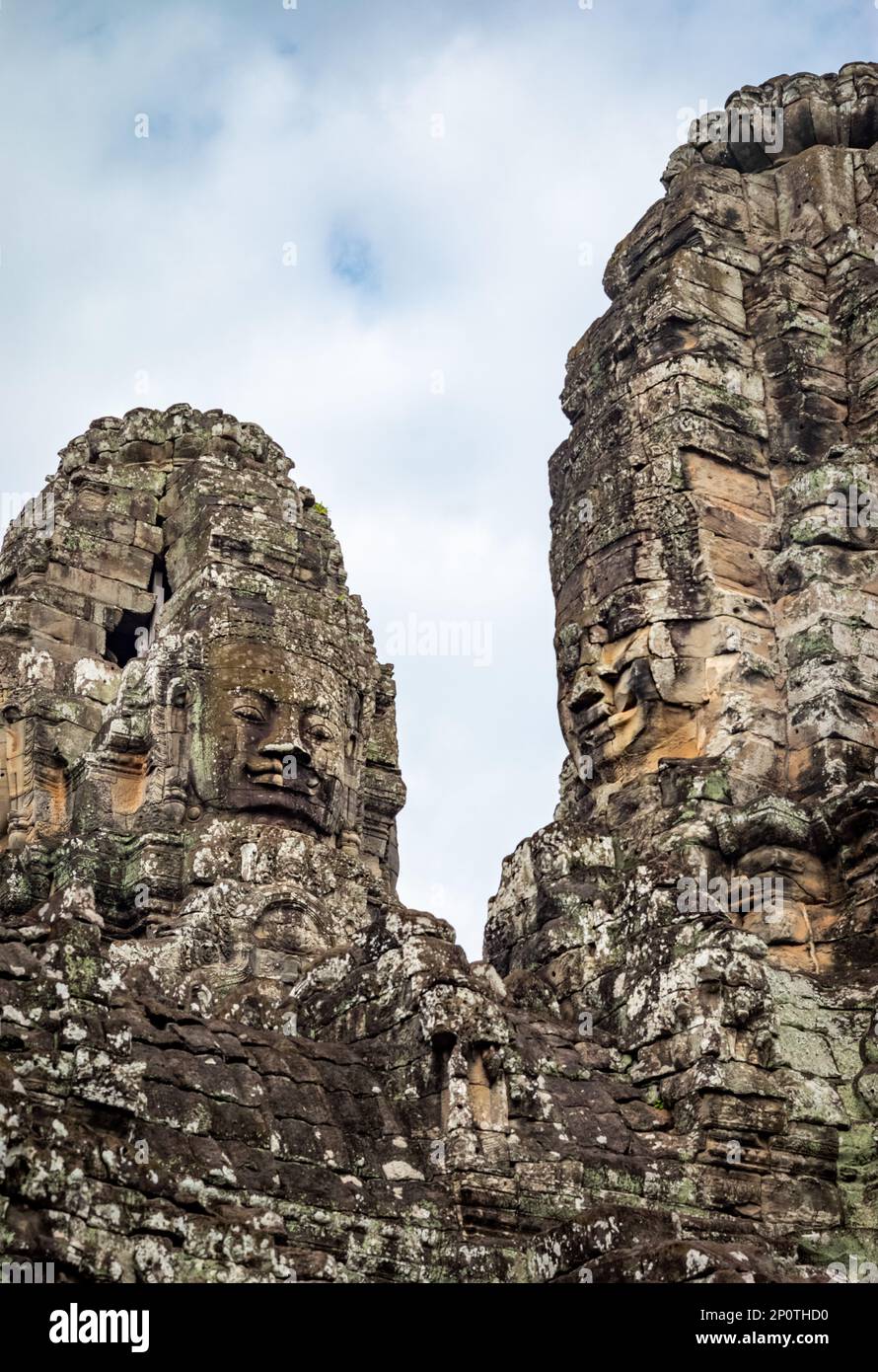 Giant carved stone faces are seen on the towers of the ruins of the ...
