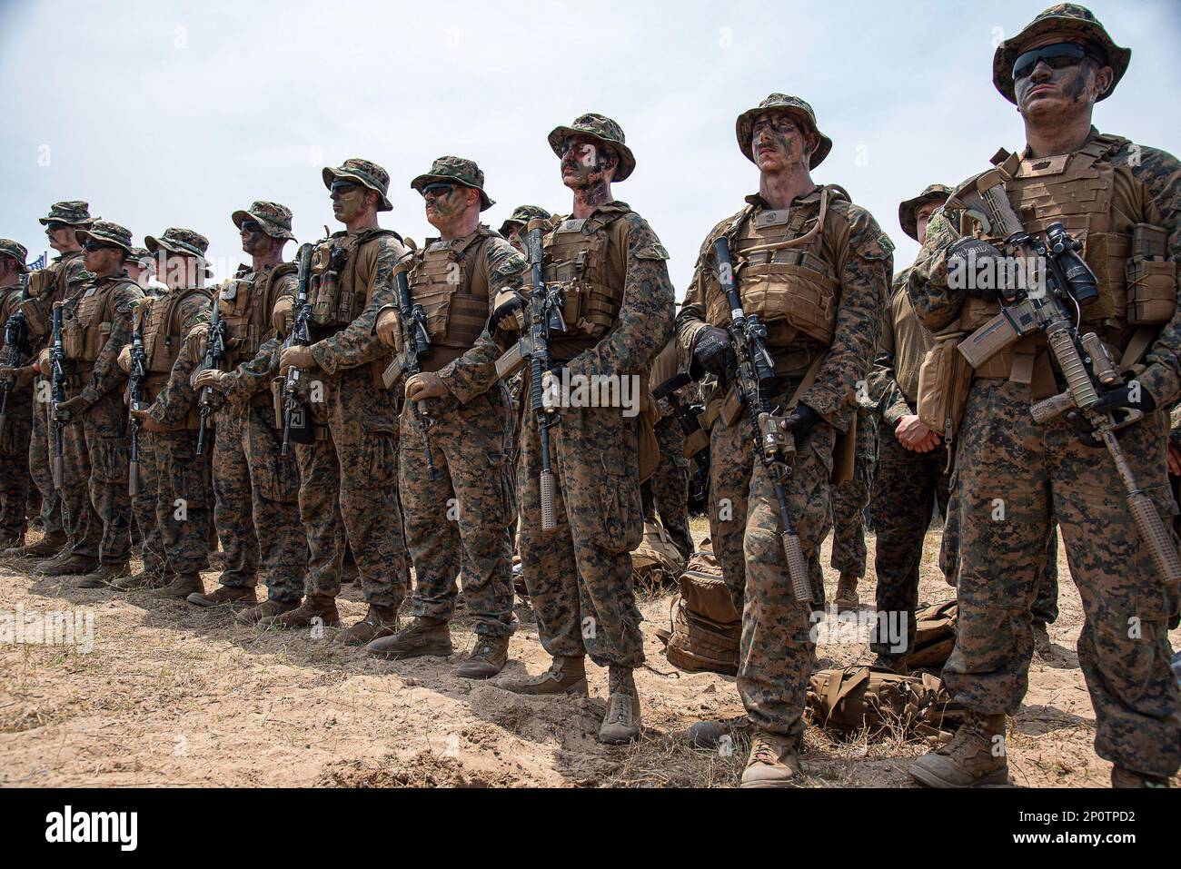 U.S. Marines with painted faces participate in an amphibious assault ...